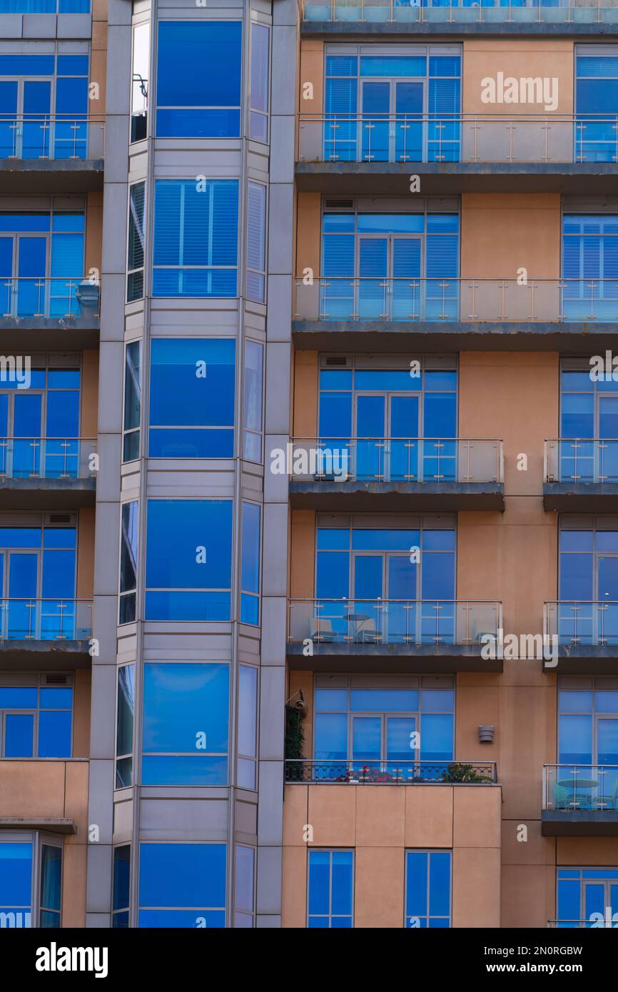 Abstract building exterior with reflective blue glass windows in ...