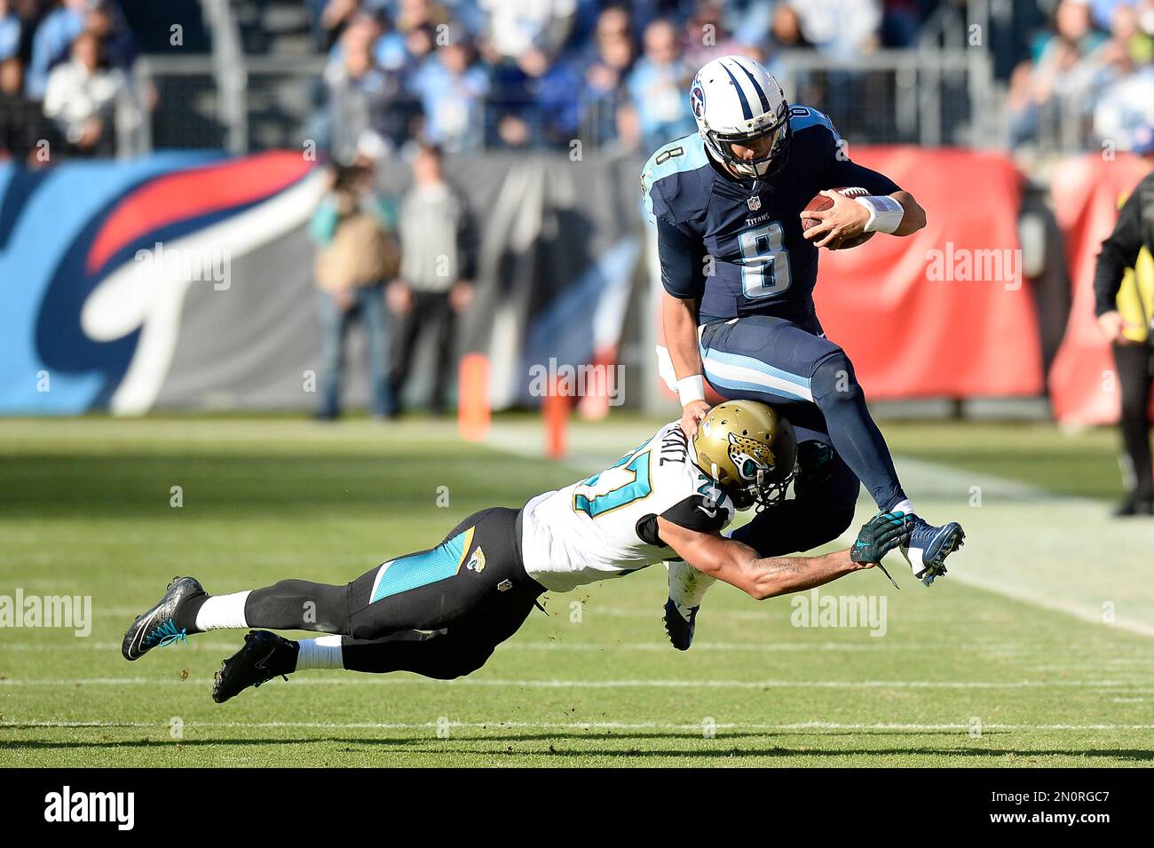Tennessee Titans quarterback Marcus Mariota (8) is hit by Jacksonville ...