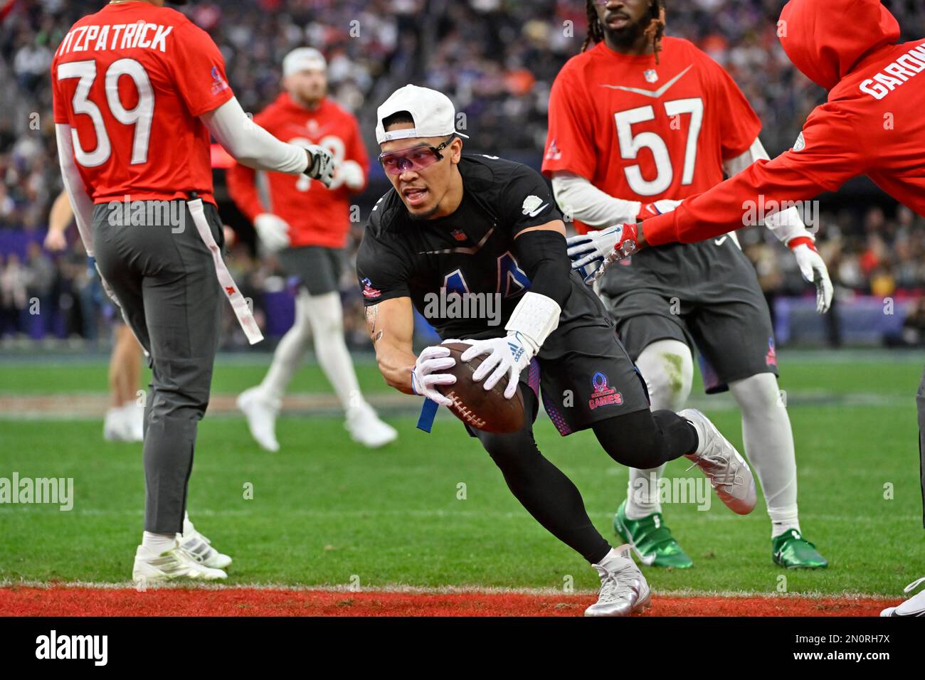 NFC wide receiver Amon-Ra St. Brown (14) of the Detroit Lions scores a touchdown during the flag ...