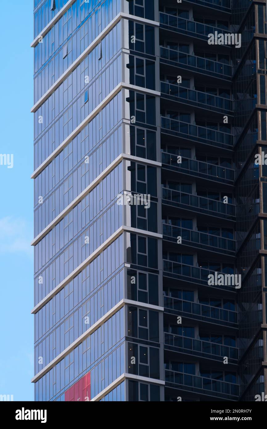 Modern city building apartment block with balconies, windows and glass ...