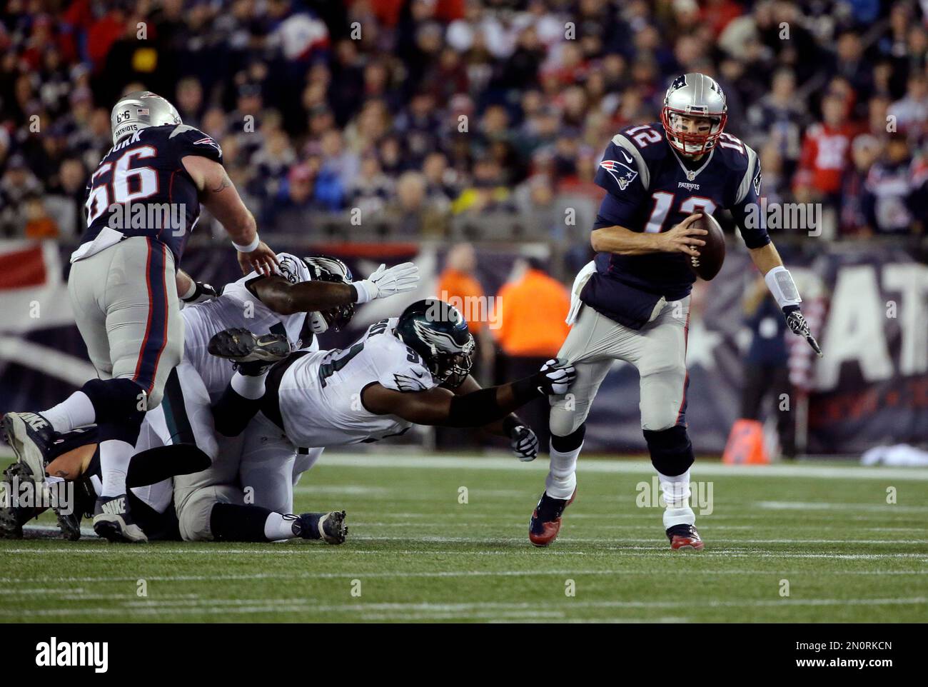 New England Patriots quarterback Tom Brady (12) scrambles away from ...