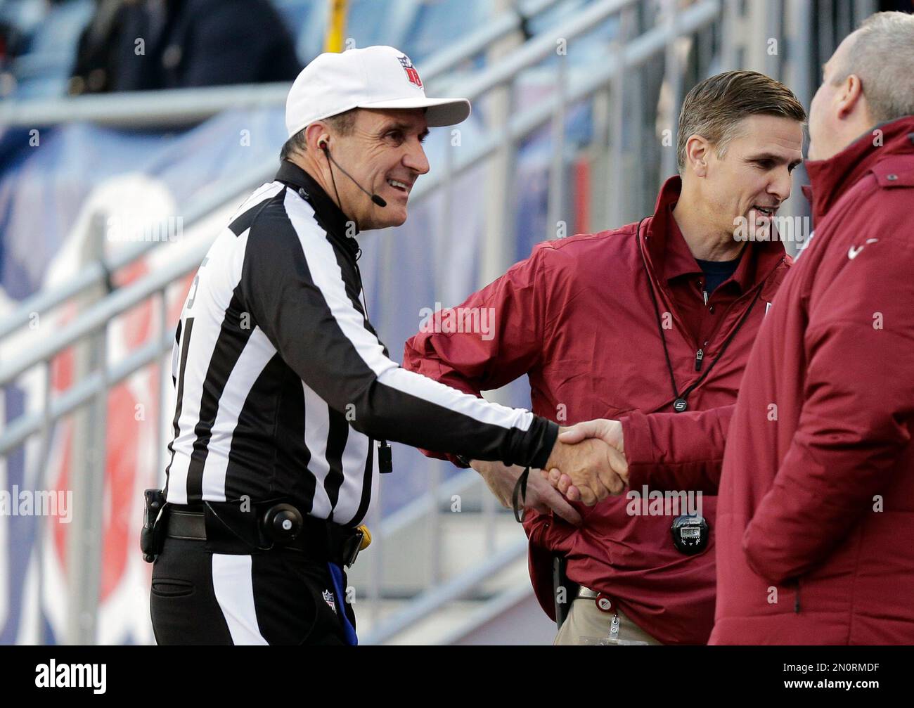 Referee Peter Morelli, left, greets people on the sideline before an ...