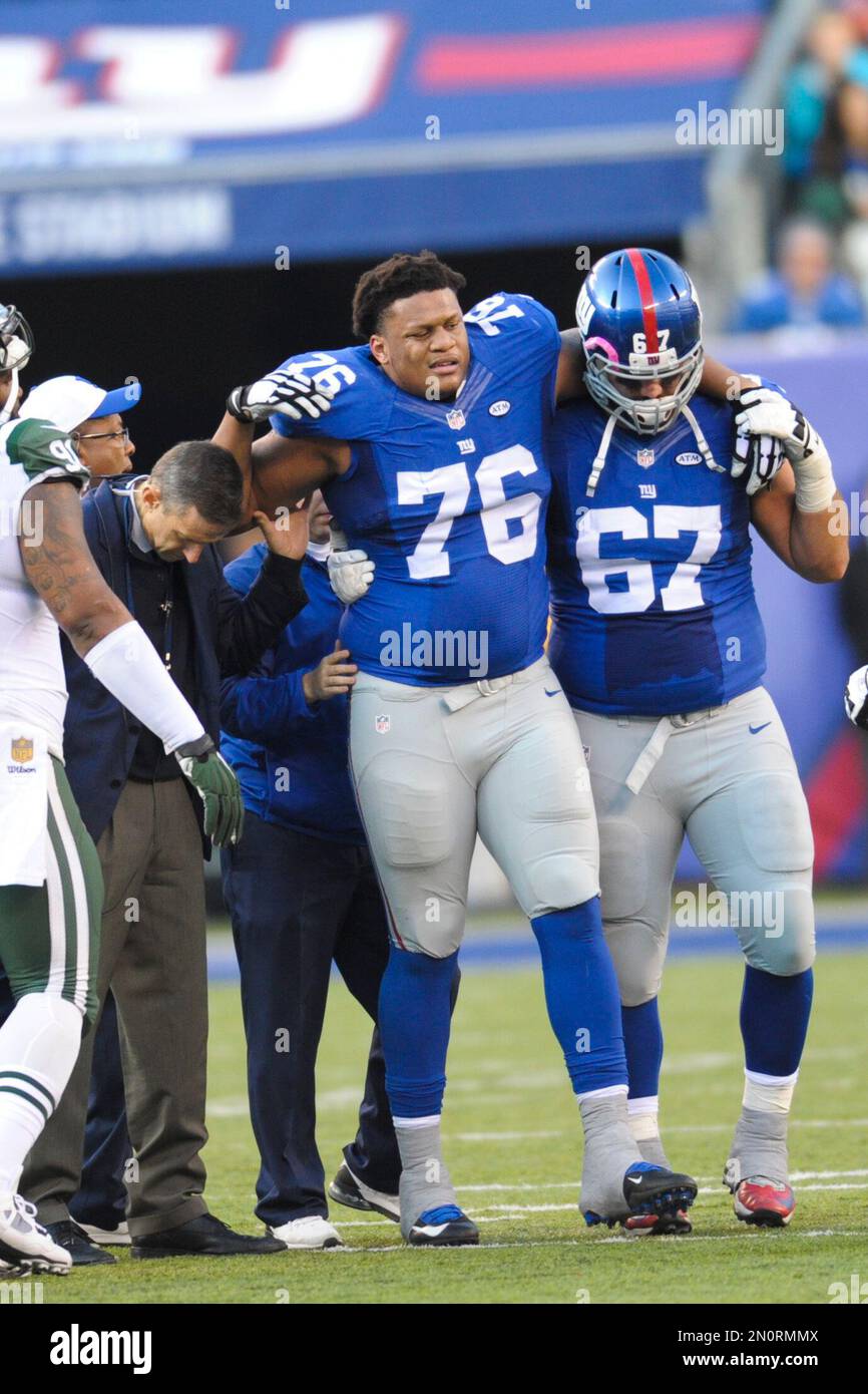 New York Giants offensive tackle Ereck Flowers (76) is helped off the ...