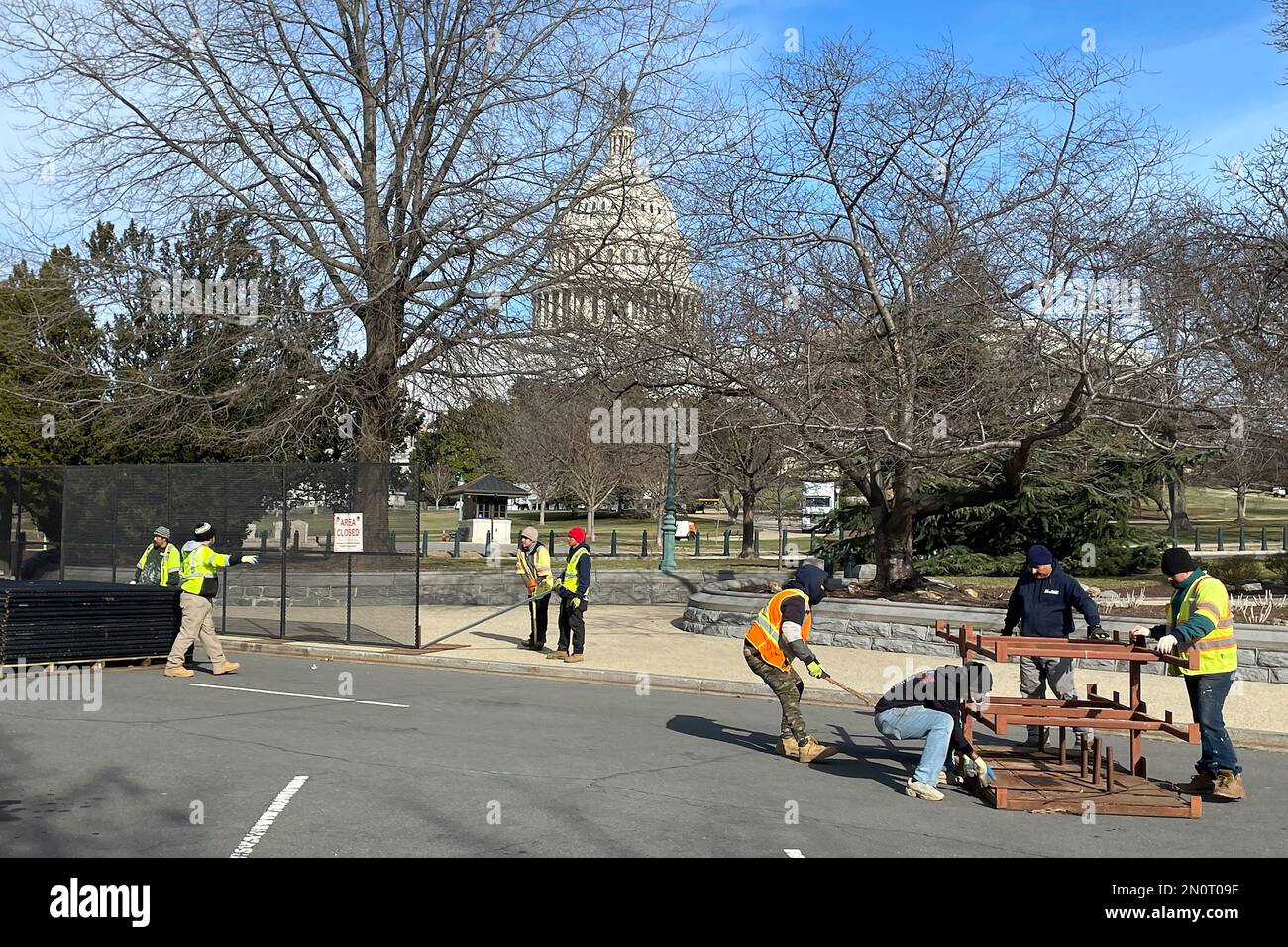 Workers construct a perimeter fence around the U.S. Capitol, Sunday ...