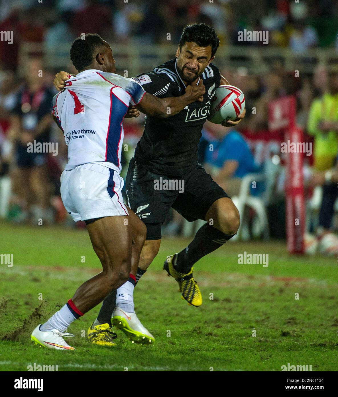 Sherwin Stowers of News Zealand tries to escape the tackle from Carlin ...