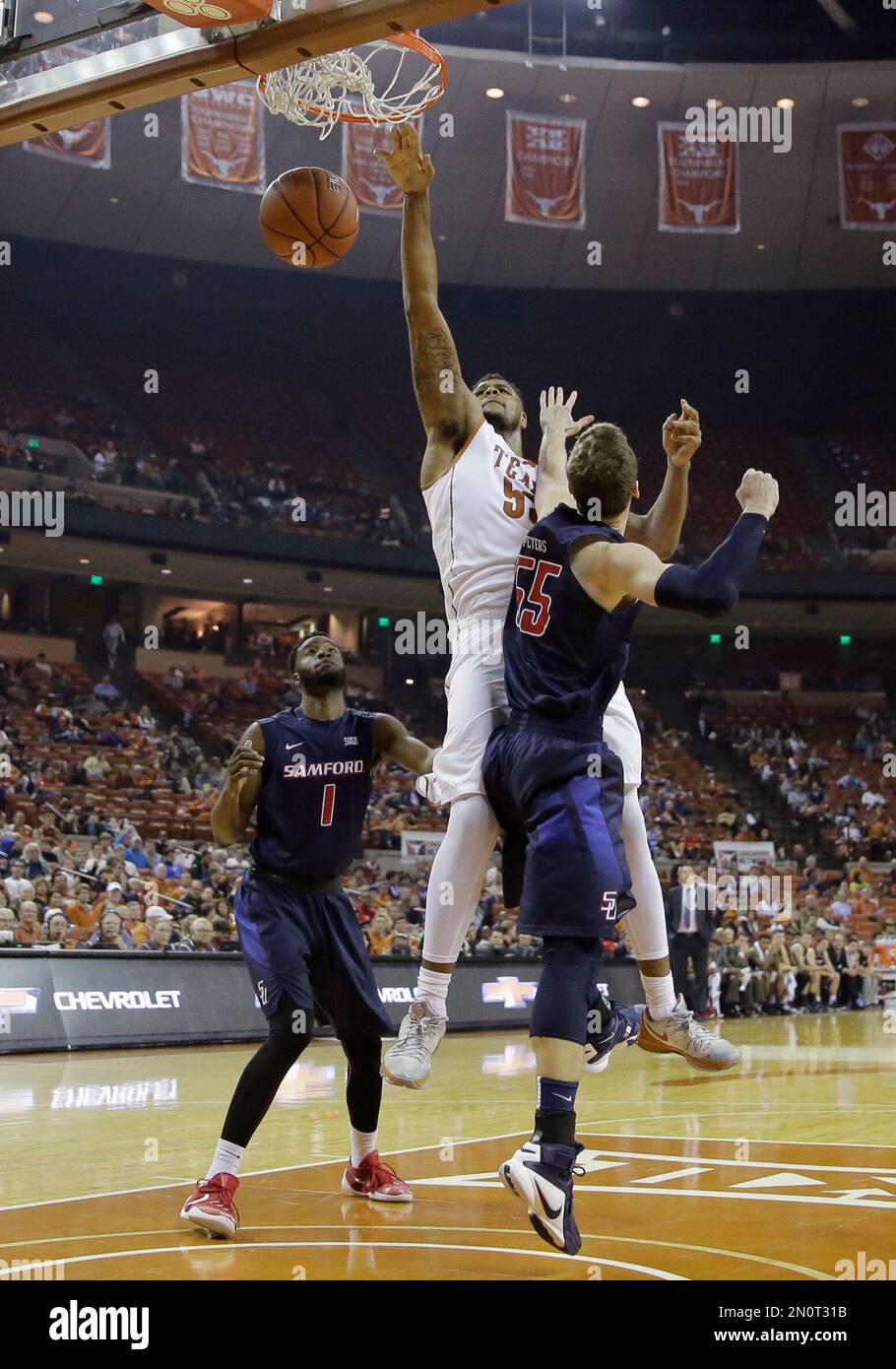 Texas center Cameron Ridley, center, scores over Samford forward Alex ...