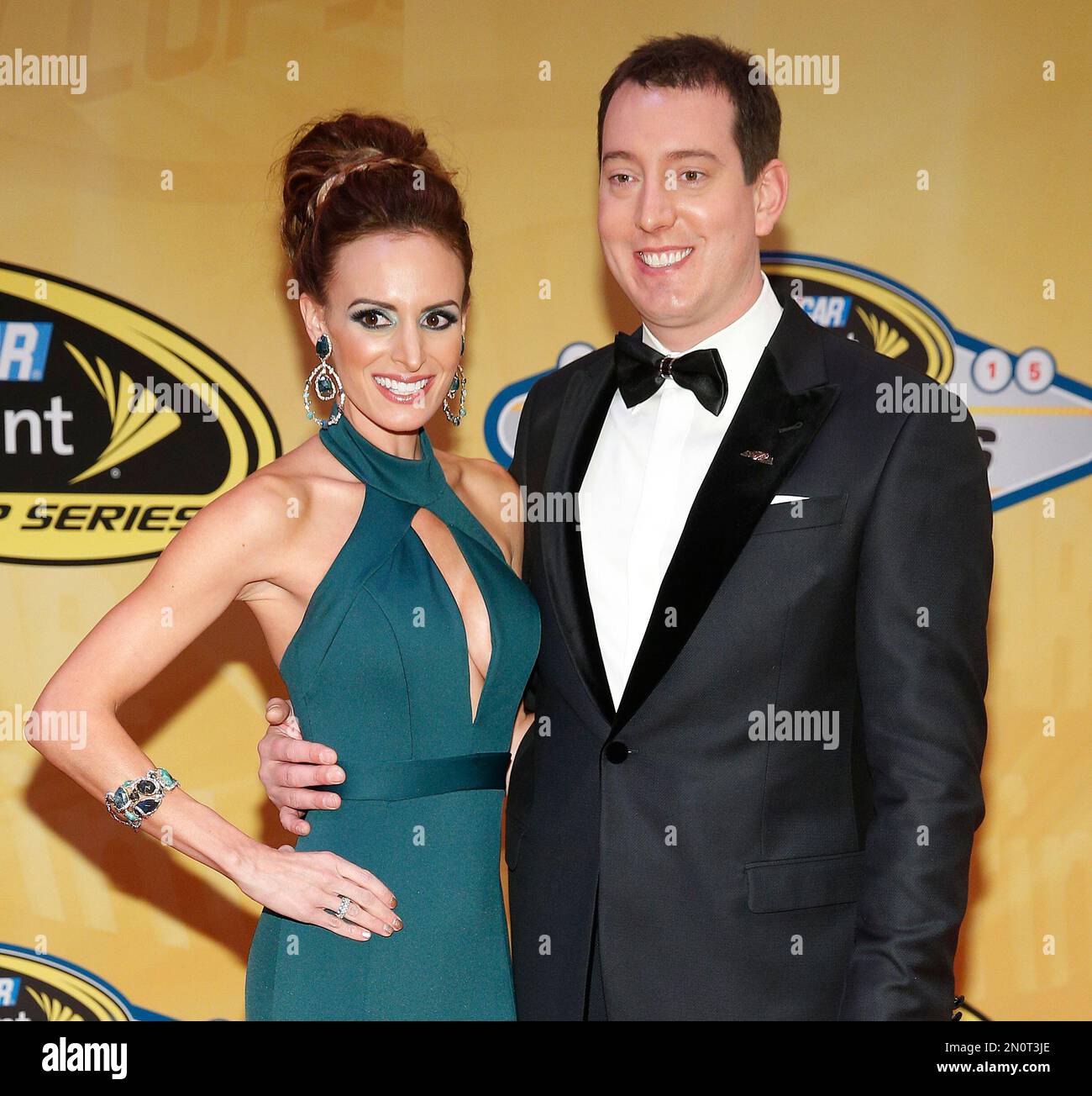 Kyle Busch and his wife, Samantha, pose on the red carpet before the ...