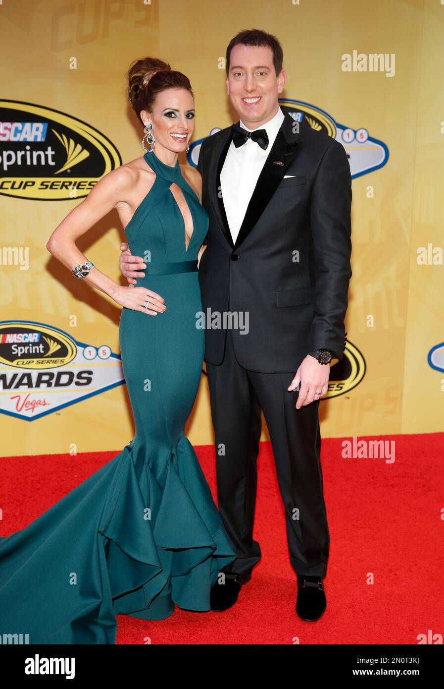 Kyle Busch and his wife, Samantha, pose on the red carpet before the ...