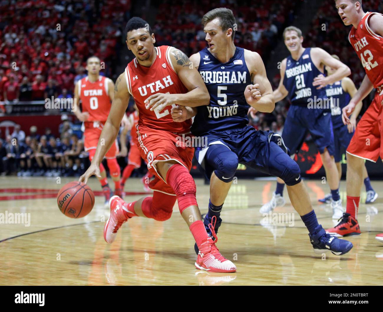 Utah forward Jordan Loveridge (21) drives as BYU guard Kyle ...