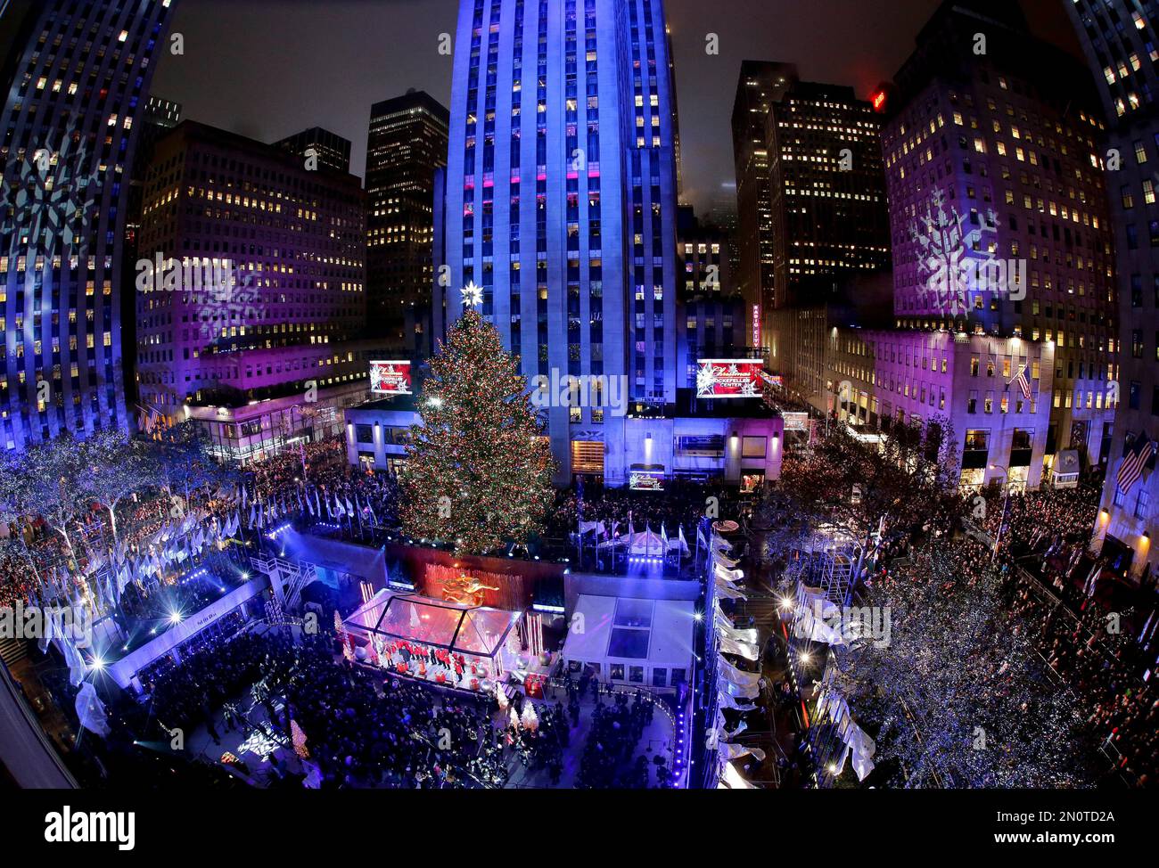 People watch as the Rockefeller Center Christmas tree is lit during a ...