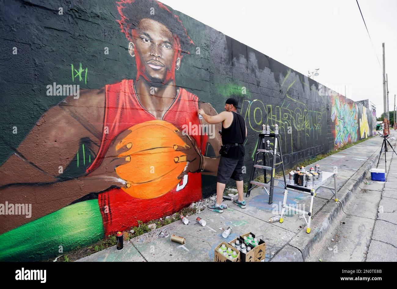 Artist Jay Mack paints a piece called Charge Your Game on a wall in the ...