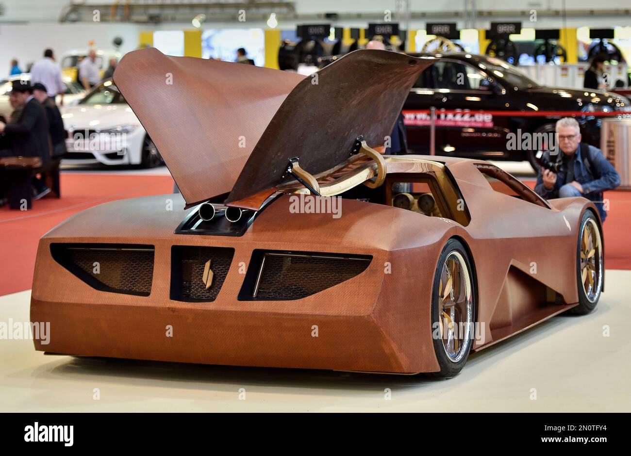 Visitors look at the wooden "splinter" car at the Motor Show in the ...