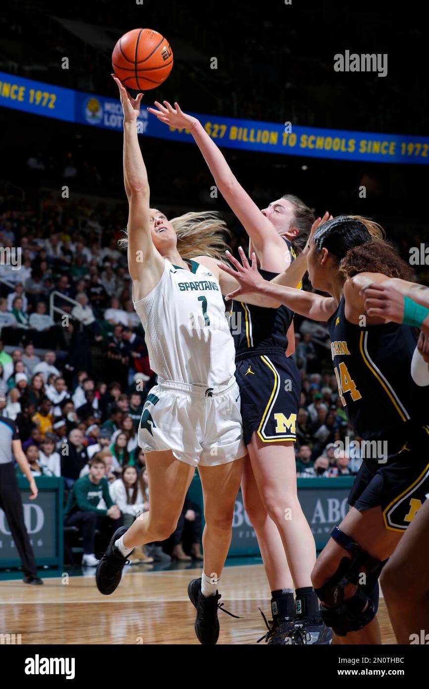 Michigan State's Tory Ozment, left, shoots against Michigan's Alyssa ...