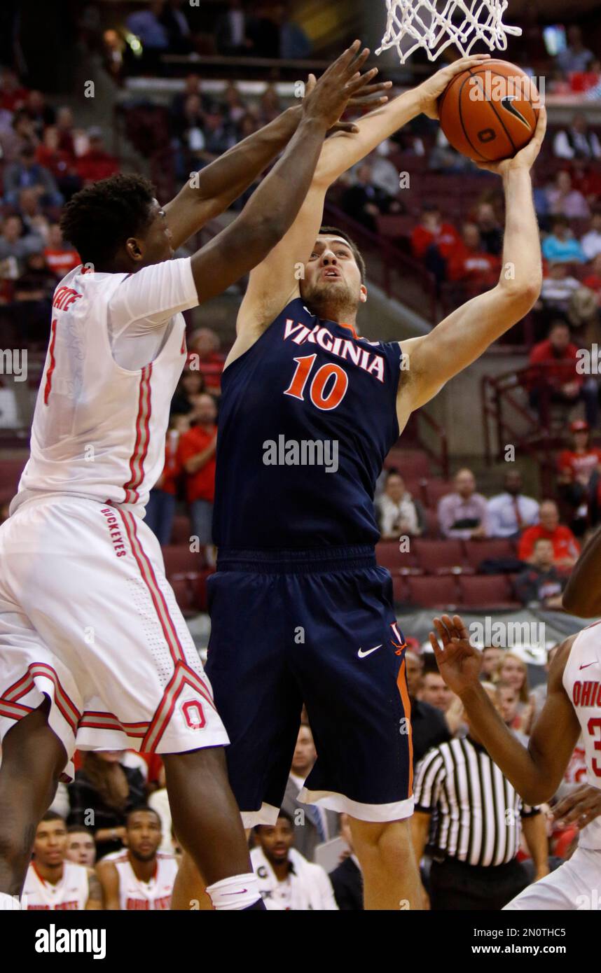 Virginia's Mike Tobey, right, goes up for a shot against Ohio State's ...