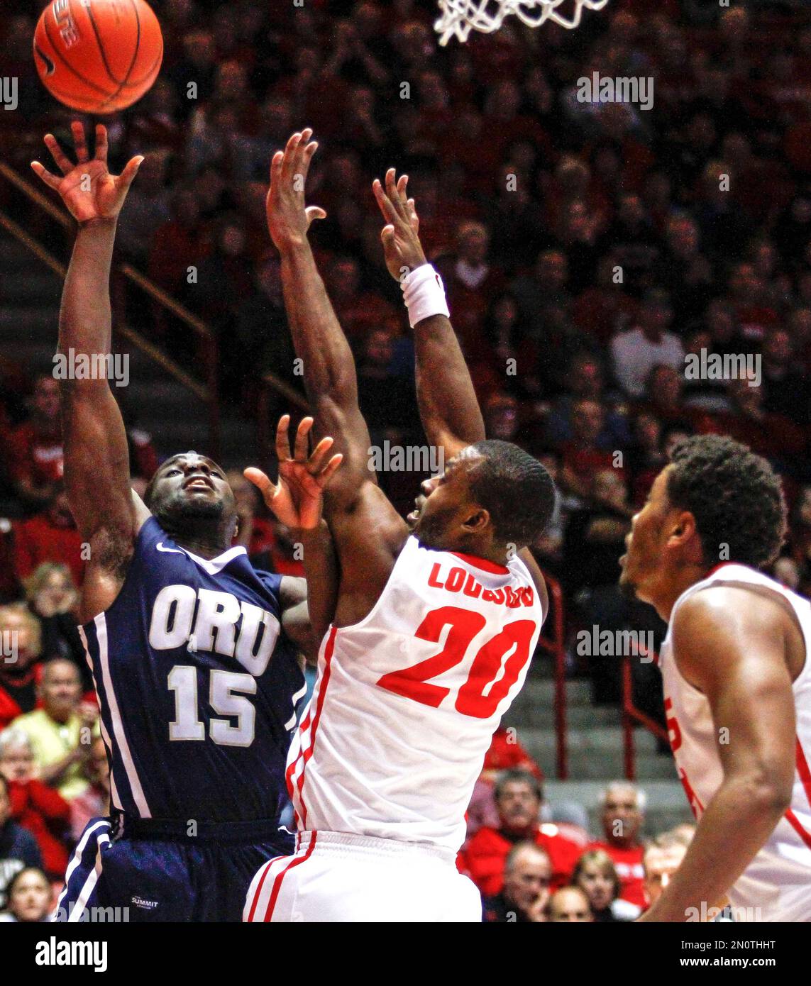 Oral Roberts' Obi Emegano (15) shoots over New Mexico's Sam Logwood (20 ...