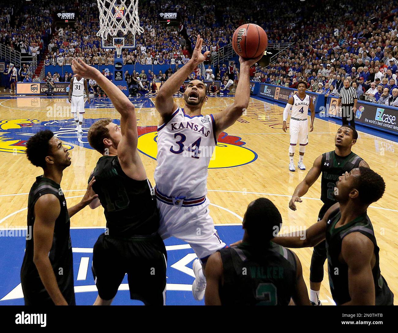 Kansas' Perry Ellis (34) gets past a group of Loyola defenders to put ...