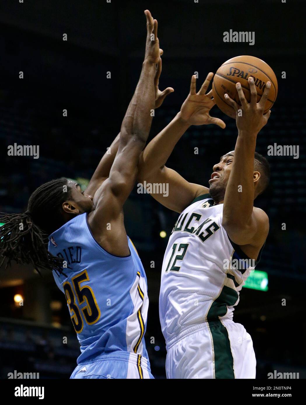 Milwaukee Bucks' Jabari Parker (12) attempts a shot against Denver ...