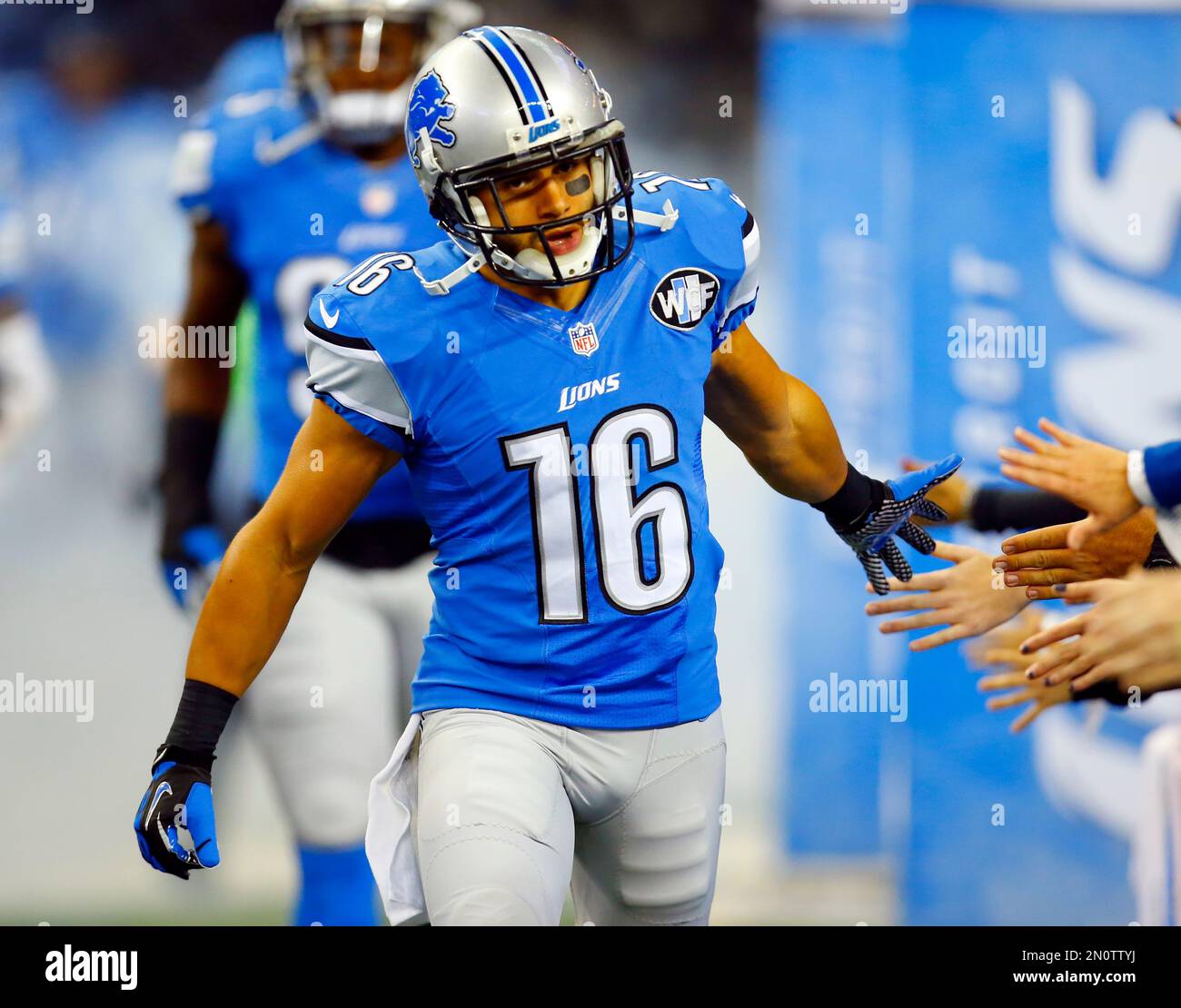 Detroit Lions wide receiver Lance Moore (16) slaps hands with fans during team introductions ...