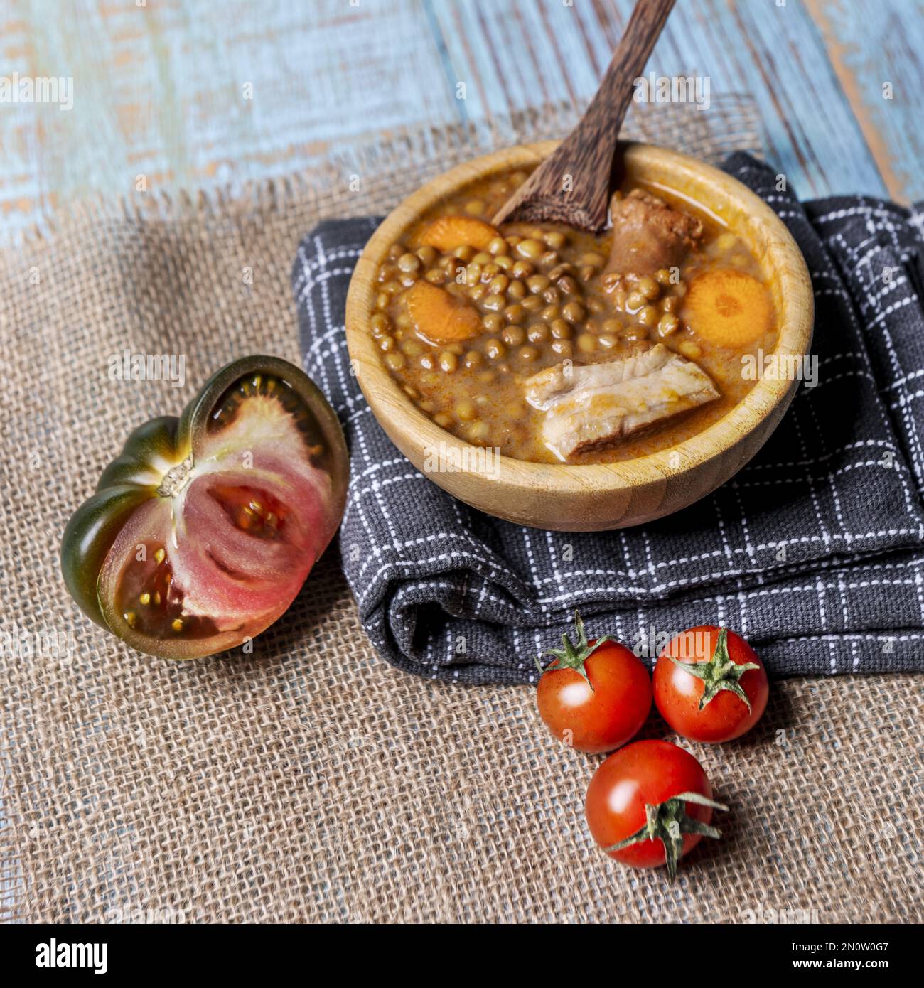 A wonderful Spanish stew of lentils with chorizo in a bamboo wooden ...