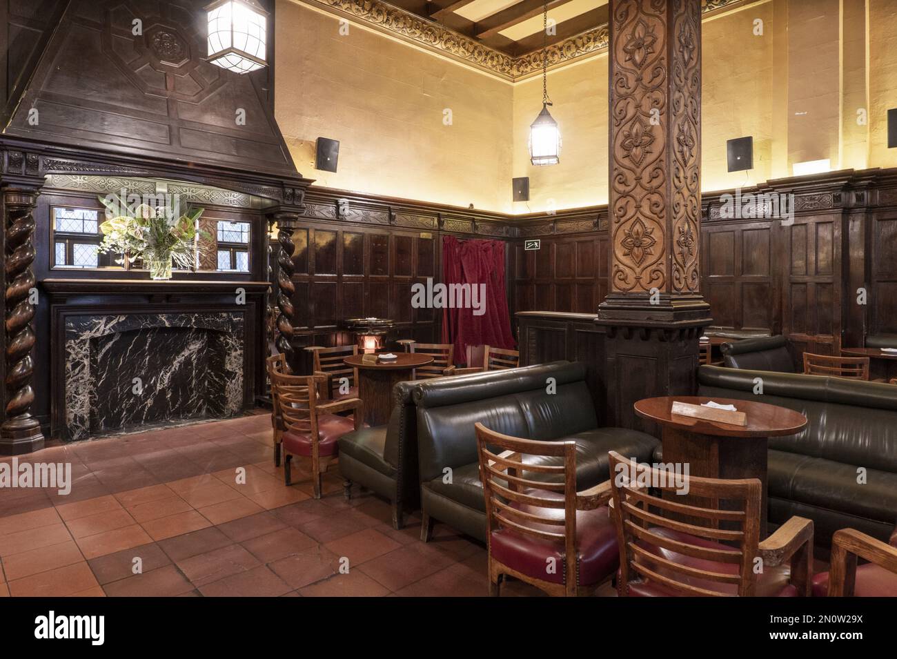 Lounge of a British pub type bar with leatherette upholstered sofas and ...
