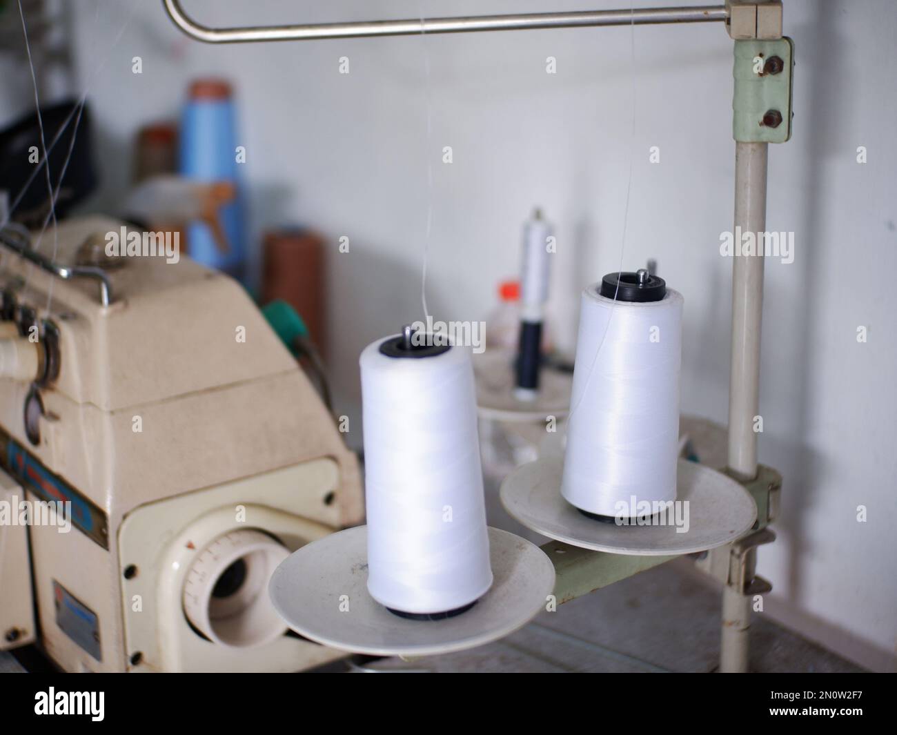 The white thread of the sewing machine that is being installed in the ...