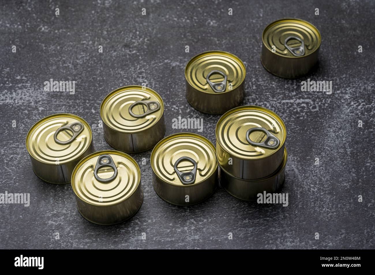 Some unopened circular cans of canned food with tabs for easy opening ...