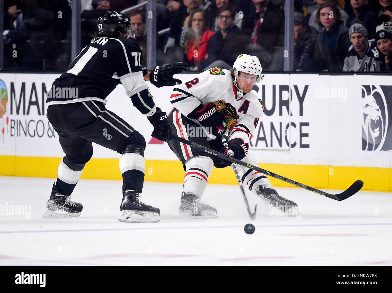 Chicago Blackhawks defenseman Duncan Keith, right, passes the puck ...