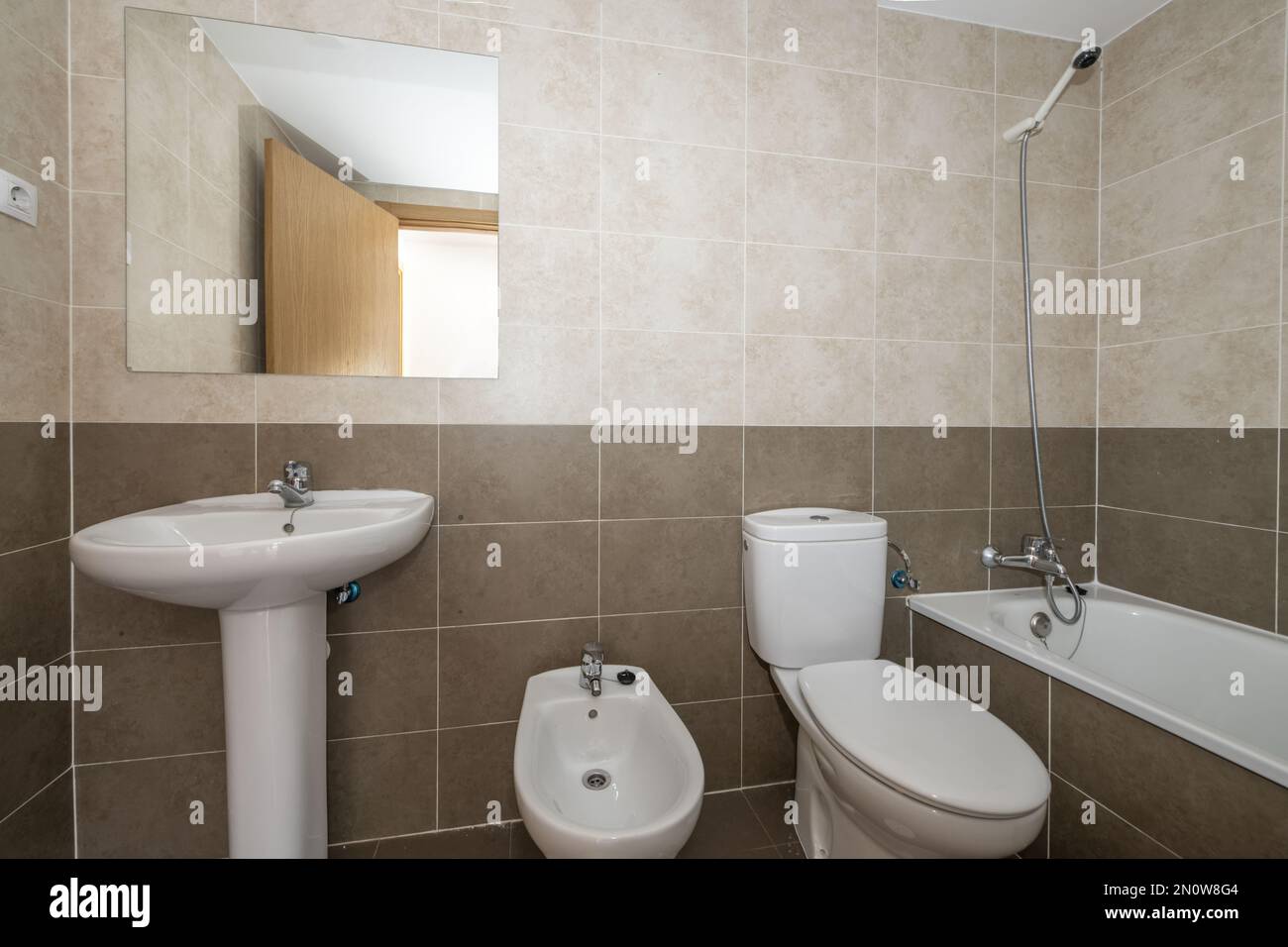 Bathroom without cabinets, with a long bathtub without screens, a ...
