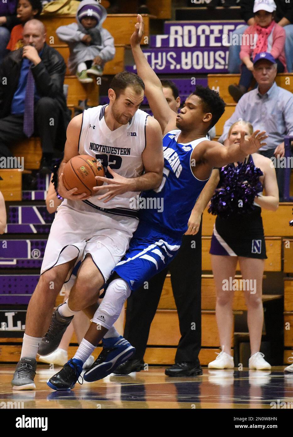 Northwestern center Alex Olah, left, drives against New Orleans forward ...