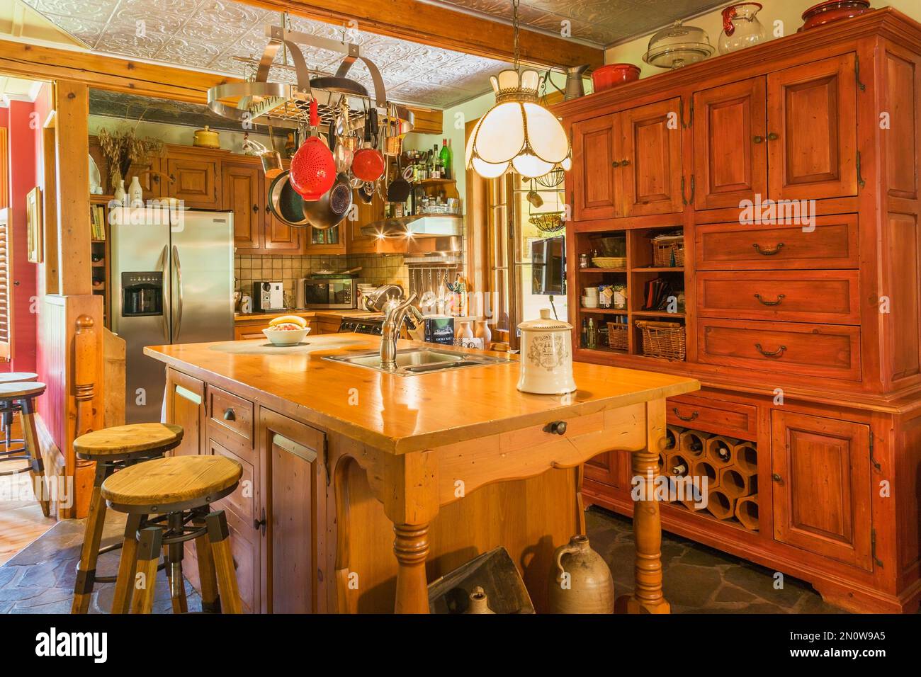 Kitchen with antique pine wood island, buffet, cabinets, slate floor ...