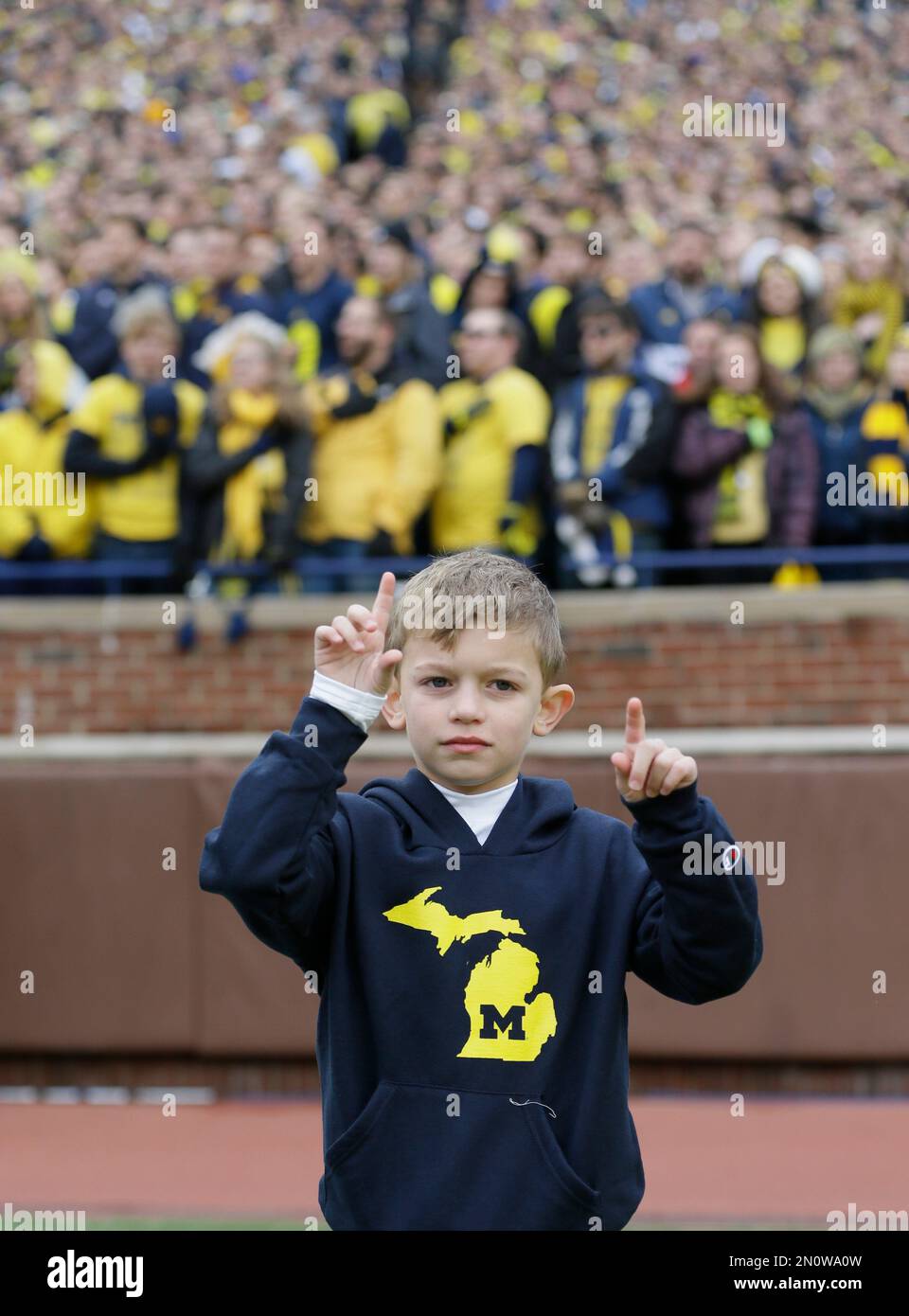 Jacob Mahoney, 8, signs the national anthem before an NCAA college ...