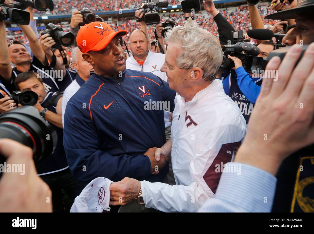 Virginia head coach Mike London, left, and Virginia Tech head coach ...