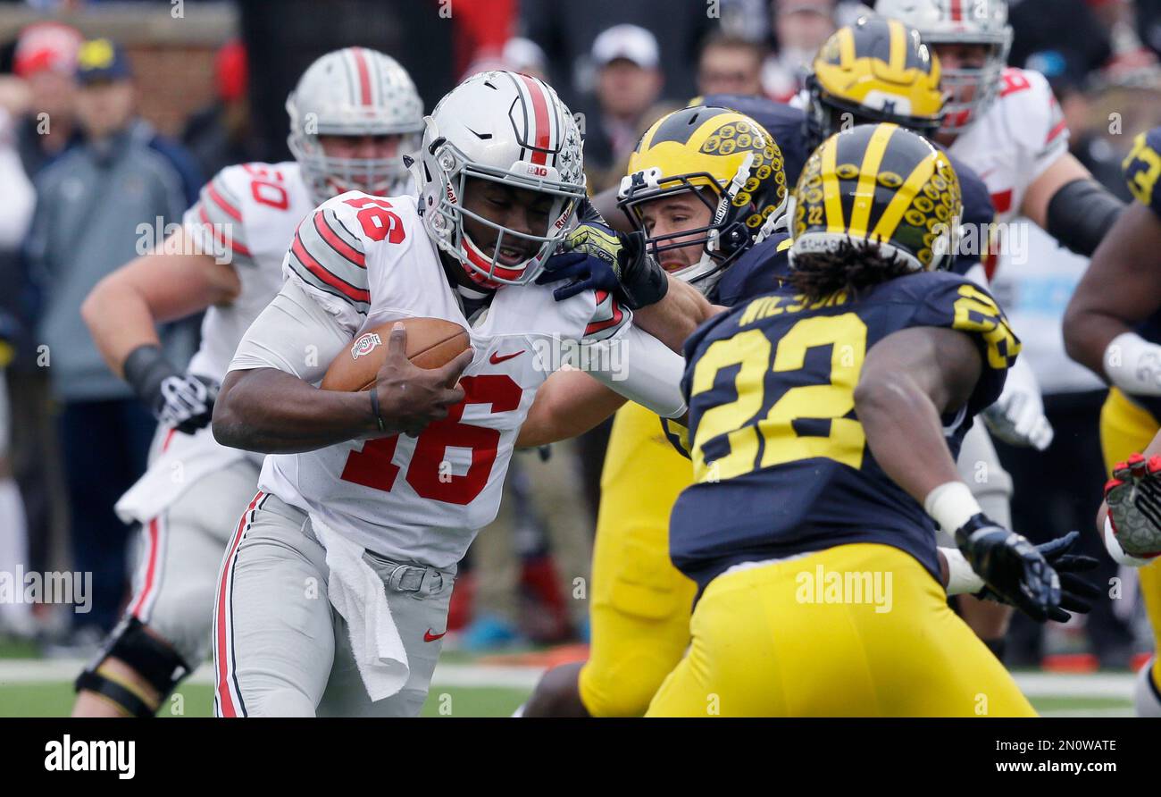 Ohio State quarterback J.T. Barrett (16) breaks away from Michigan ...