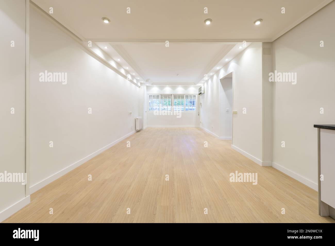 Totally empty living room with white painted walls with wooden flooring ...