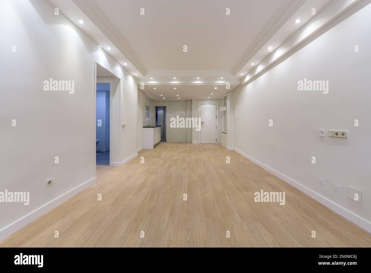 Totally empty living room with white painted walls with a wooden floor ...