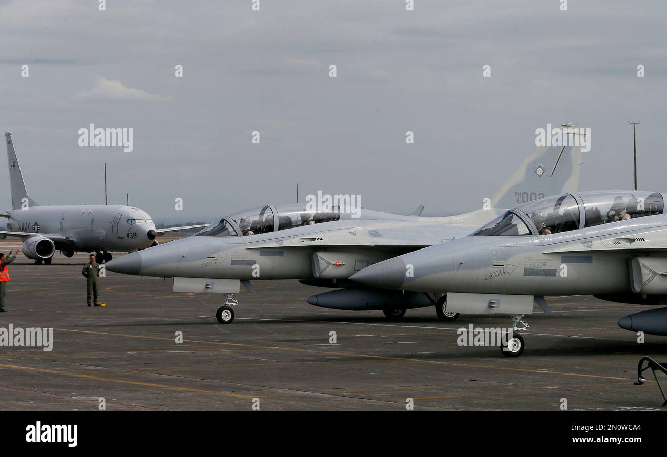 A U.S. Navy P3-Orion surveillance aircraft, left, is parked close to ...