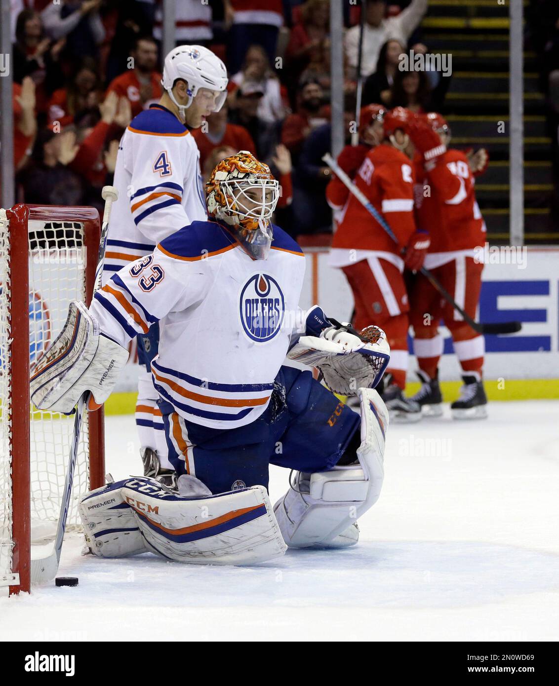 Edmonton Oilers goalie Cam Talbot (33) takes the puck out of the net as ...