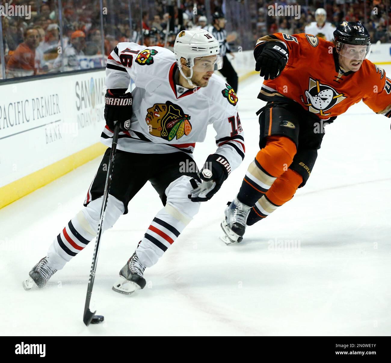 Chicago Blackhawks' Marcus Kruger, left, controls the puck ahead of ...