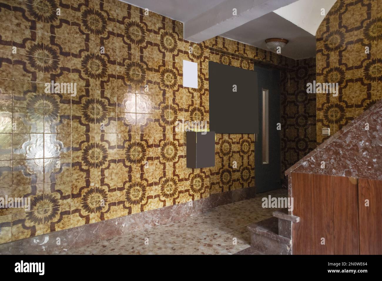 Elevator inside an old building with horrible tiles on the wall Stock ...