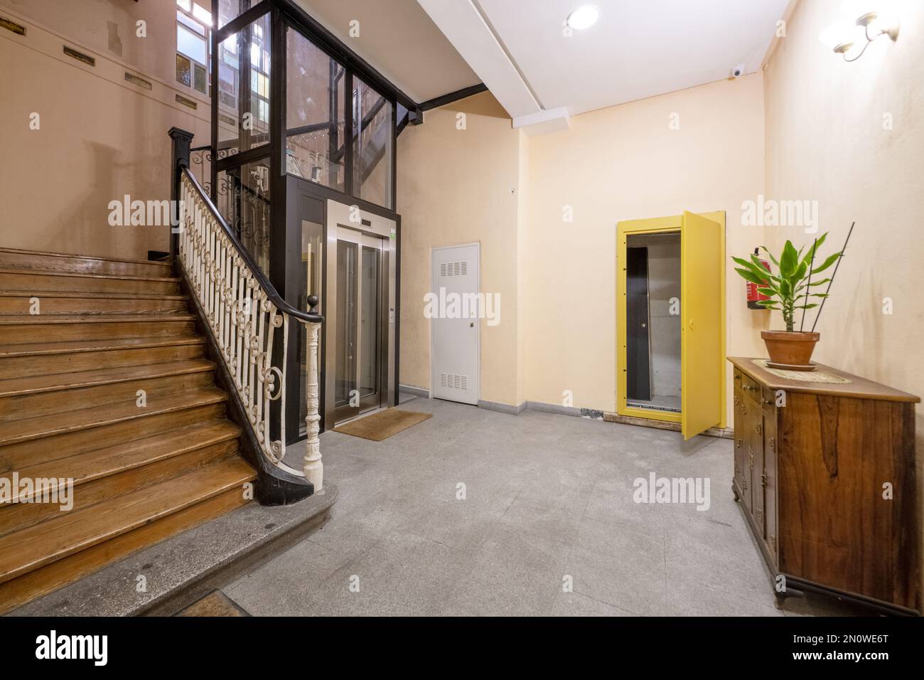 Renovated glass and metal elevator inside an old building with wooden ...