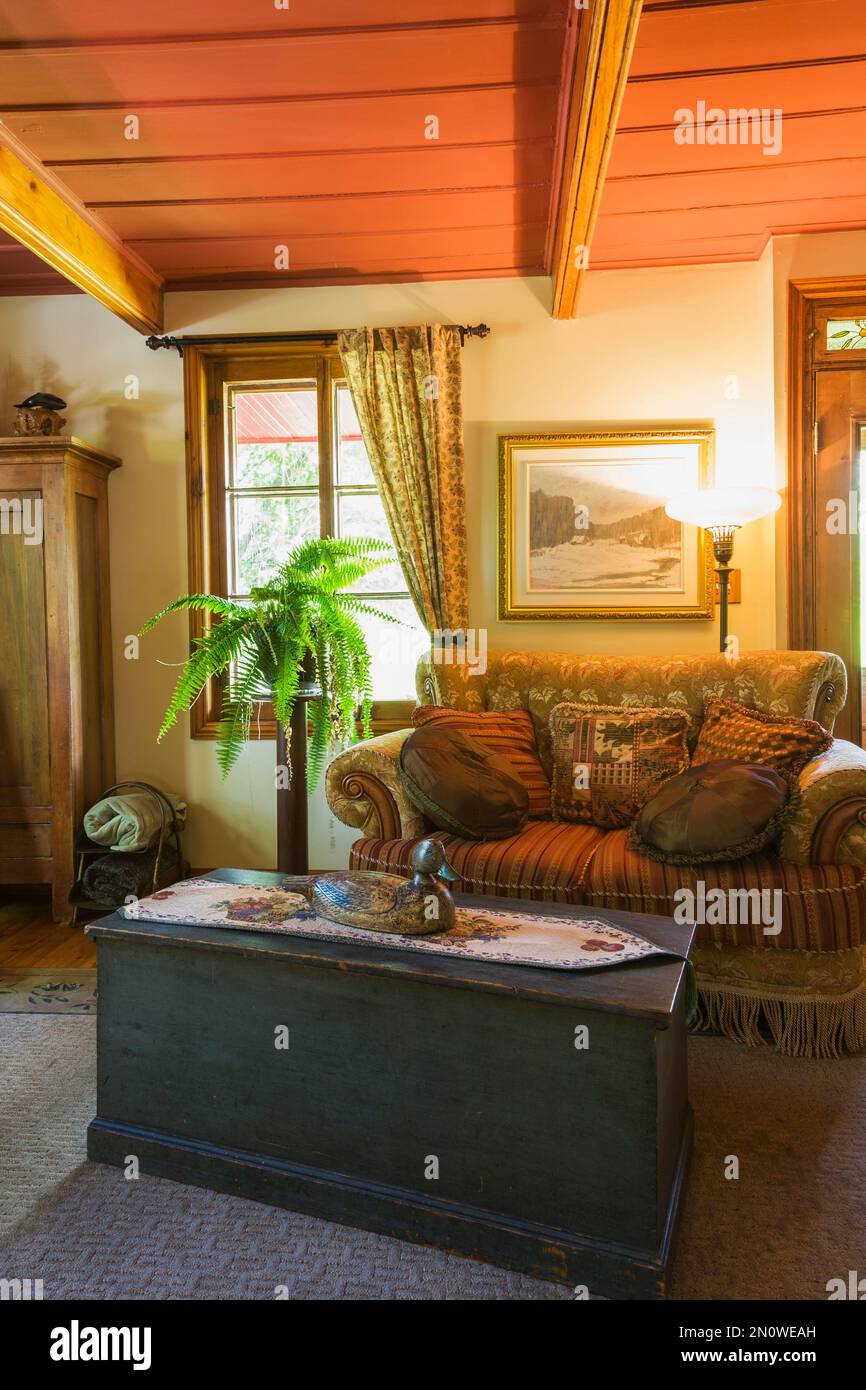 Family room with antique wooden storage chest coffee table, upholstered ...