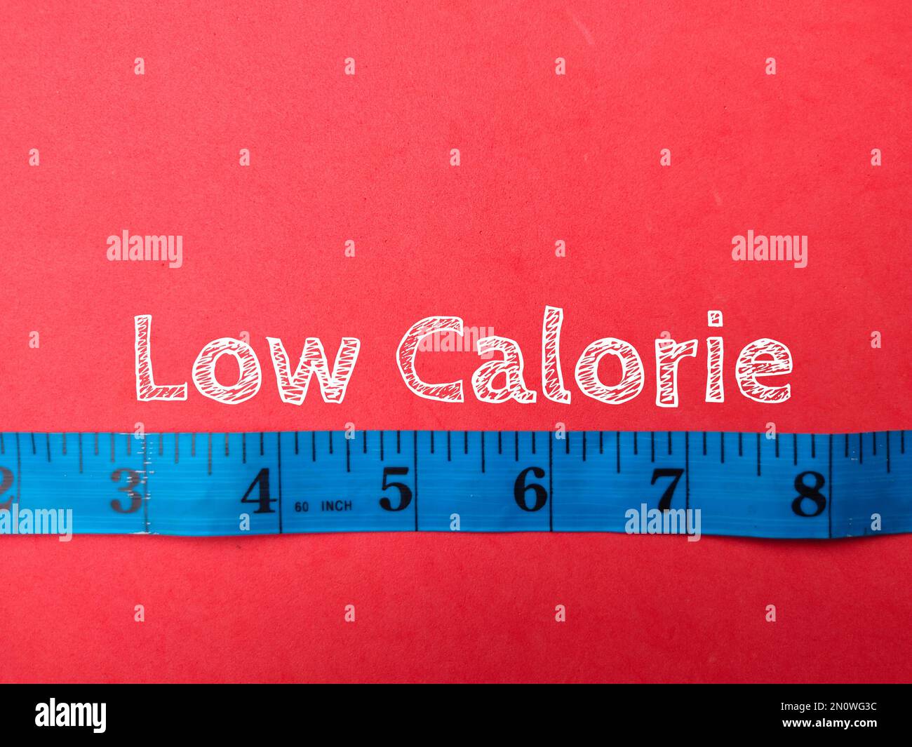 Blue measuring tape with the word Low Calorie on a red background Stock ...