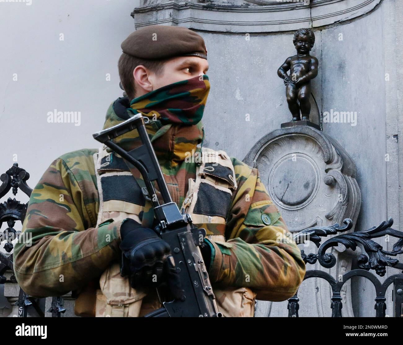 A Belgium army soldier guards the "Manneken Pis" statue, one of Brussel ...