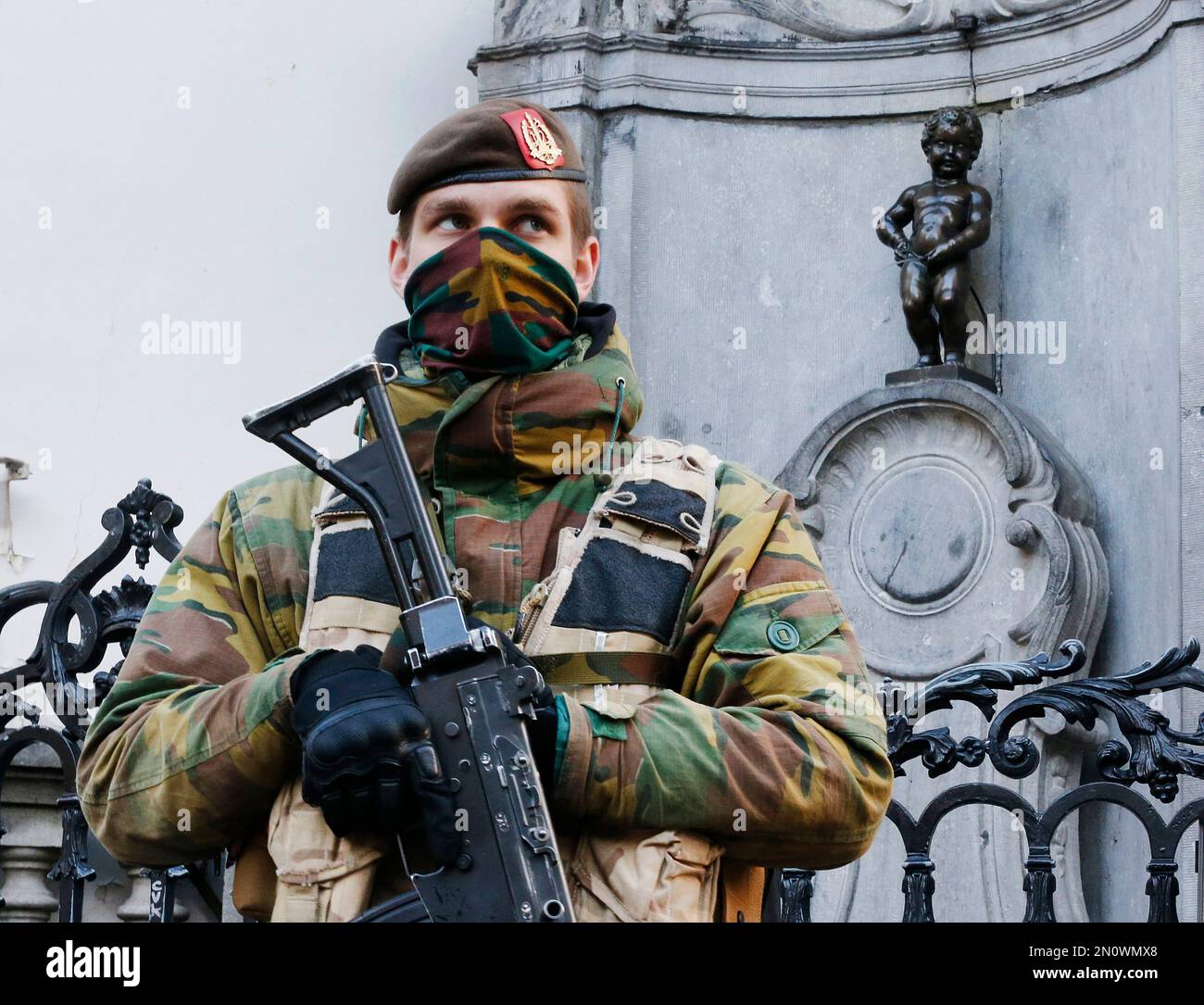 A Belgium army soldier guards the "Manneken Pis" statue, one of Brussel ...