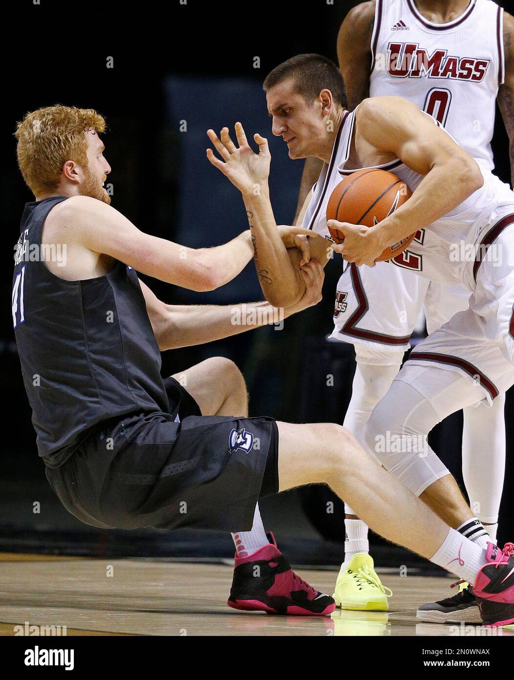 Creighton center Geoffrey Groselle, left, fouls Massachusetts forward ...