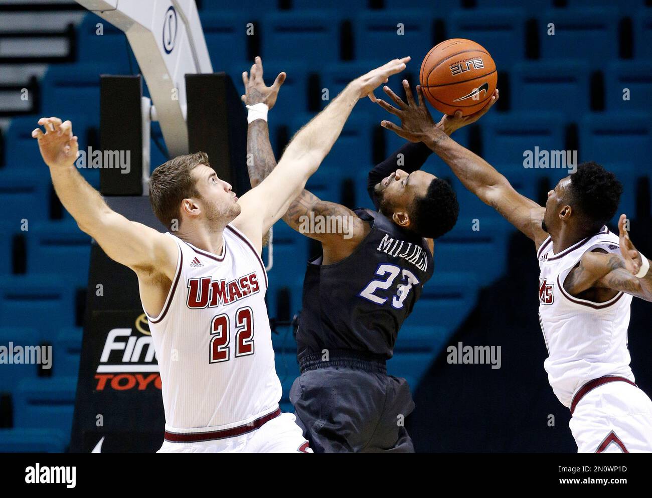 Massachusetts center Tyler Bergantino (22) and guard Donte Clark, right ...