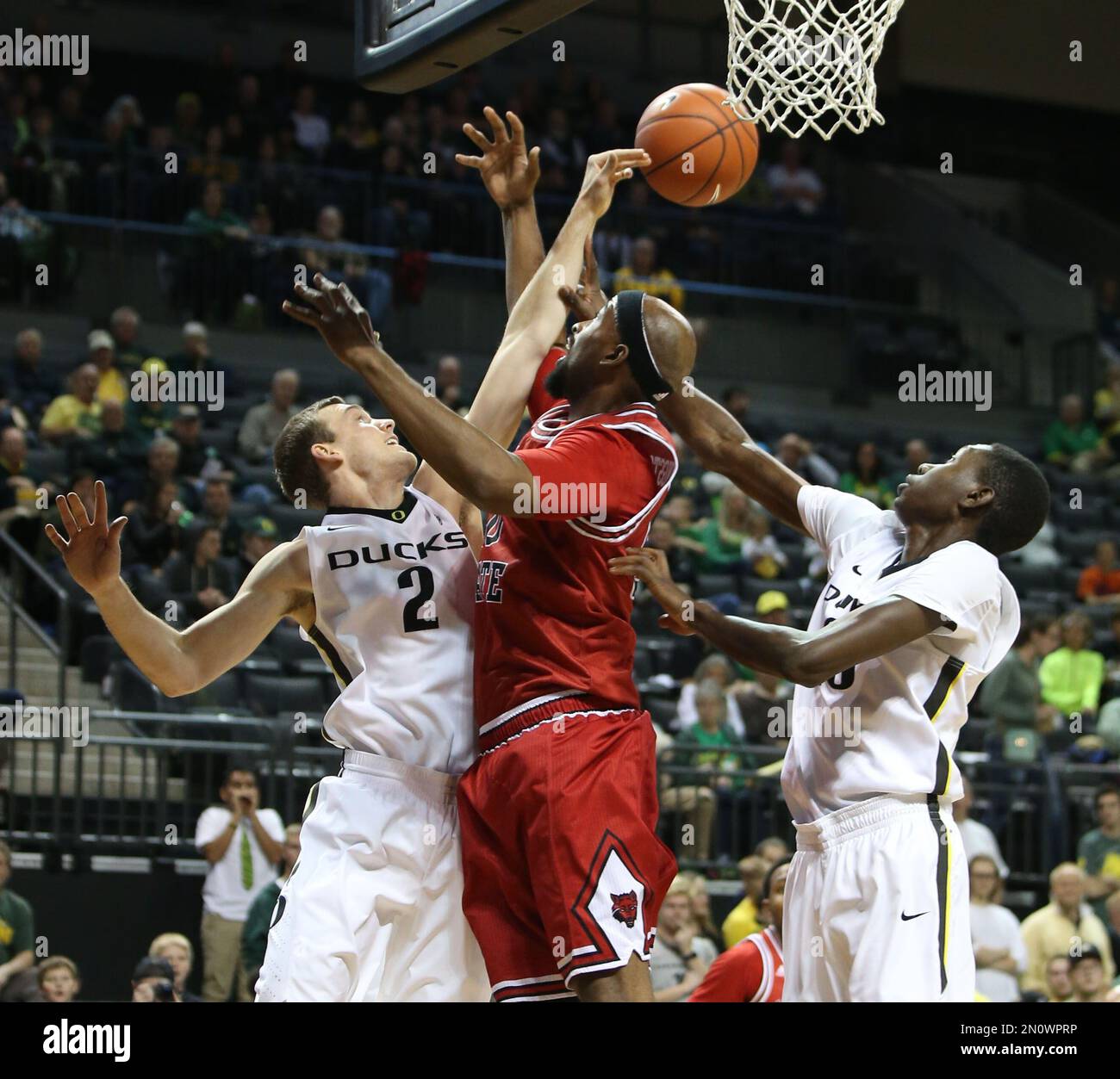 Oregon's Casey Benson, left, Arkansas State's Anthony Livingston ...