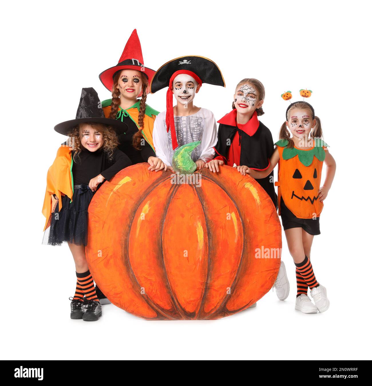 Cute little kids with decorative pumpkin wearing Halloween costumes on ...