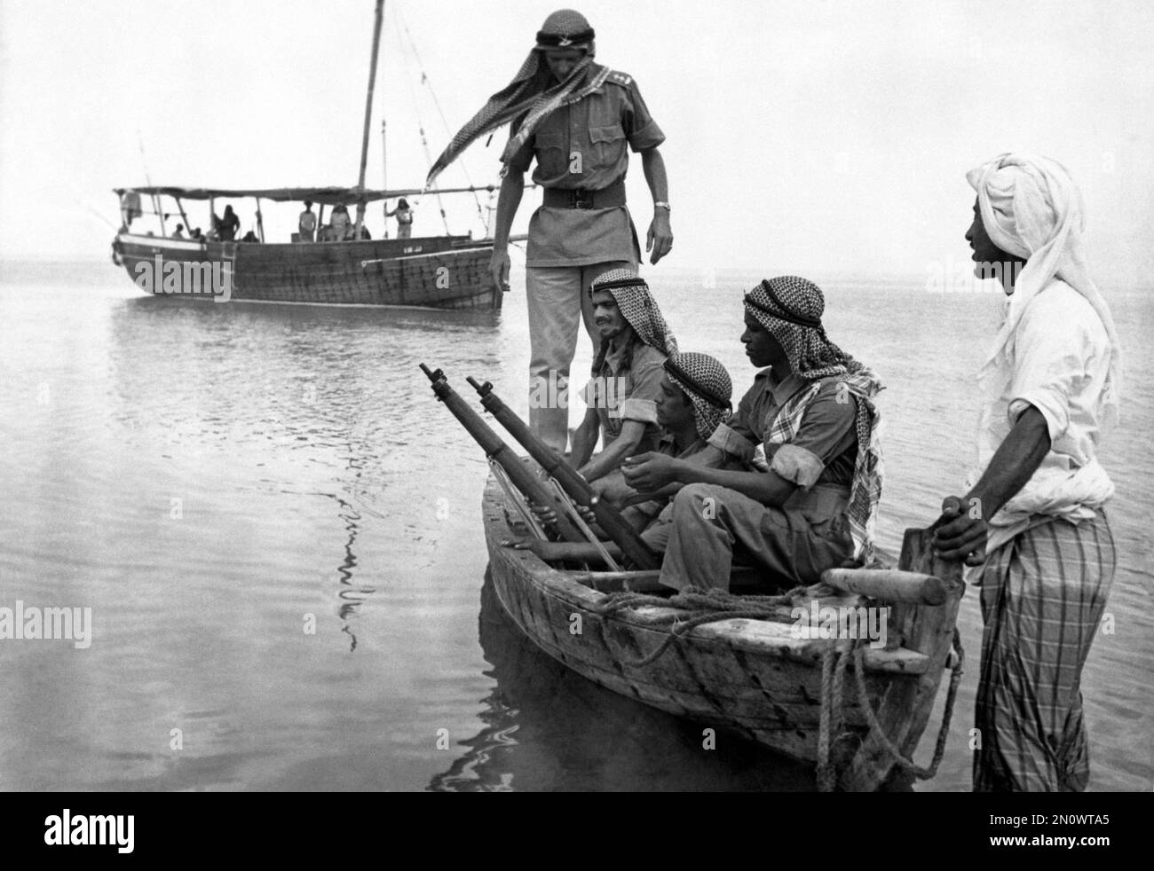 Arab soldiers of the Trucial Oman Scouts, armed with rifles, prepare to ...