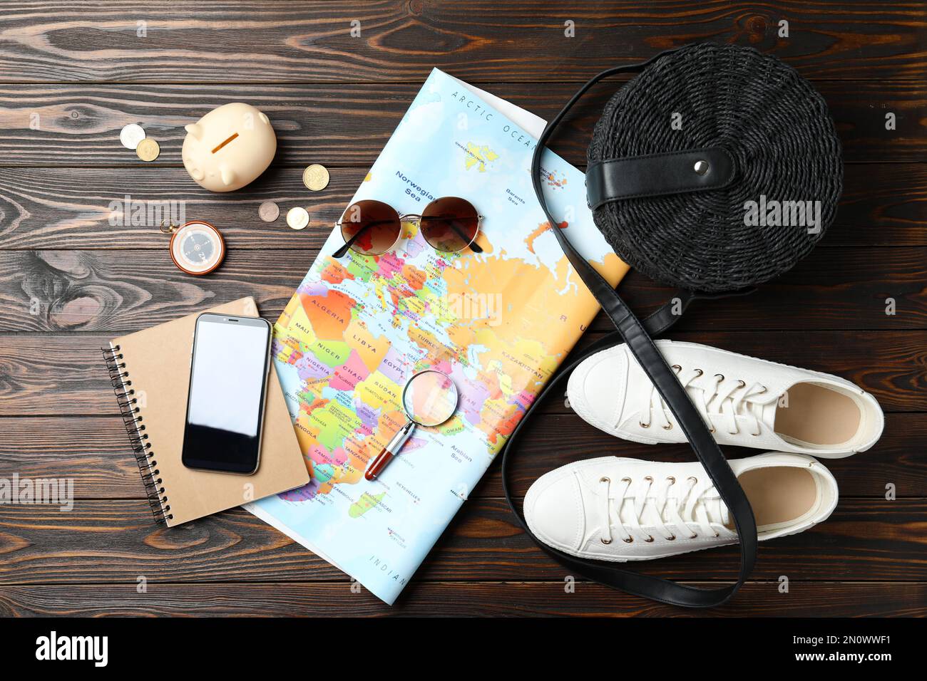World map and items on wooden background, flat lay. Travel during summer vacation Stock Photo ...